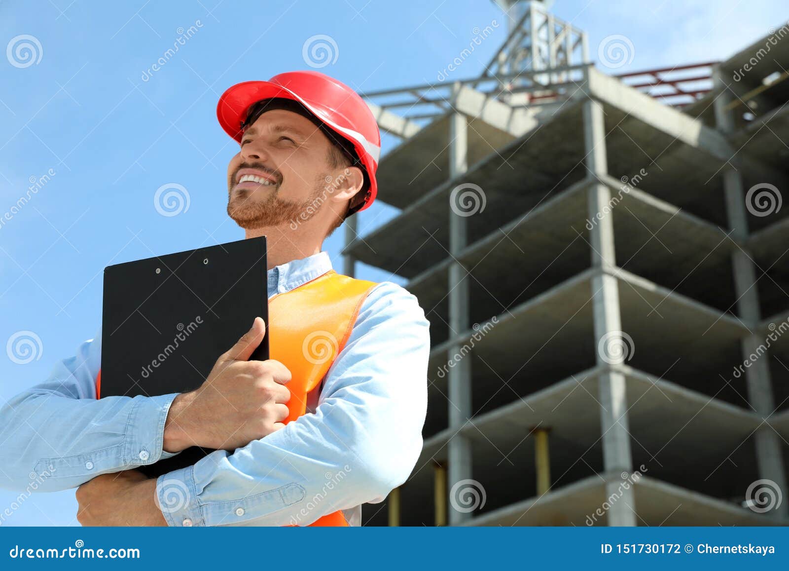 Professional Engineer in Safety Equipment with Clipboard at ...