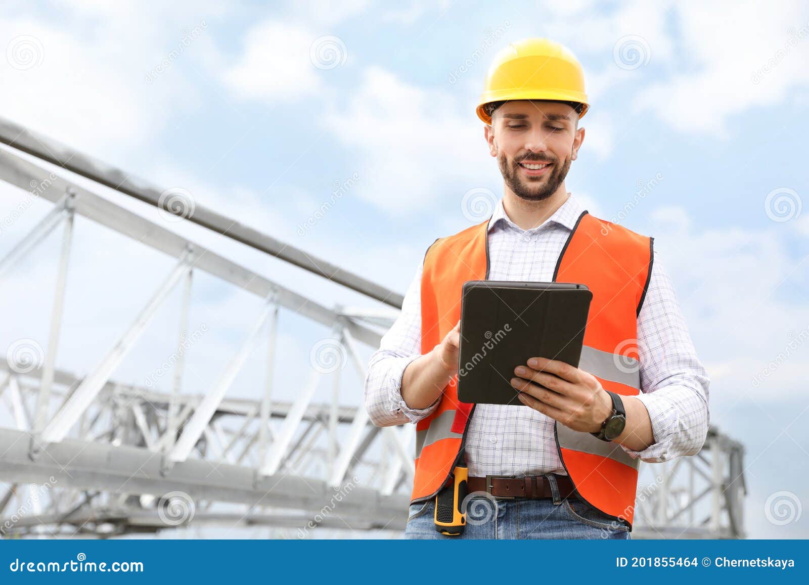 Professional Engineer with Tablet Near High Voltage Tower Construction ...