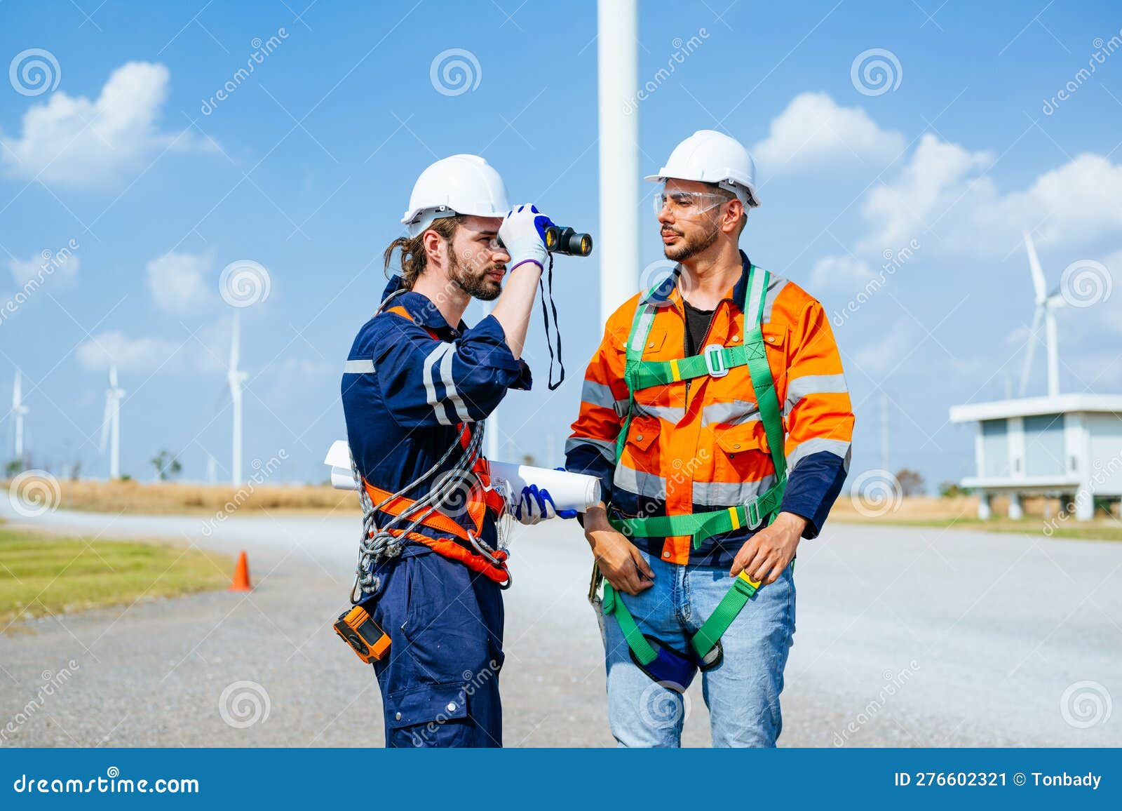 Professional Engineers Technicians Working at Wind Turbine Farm Field ...