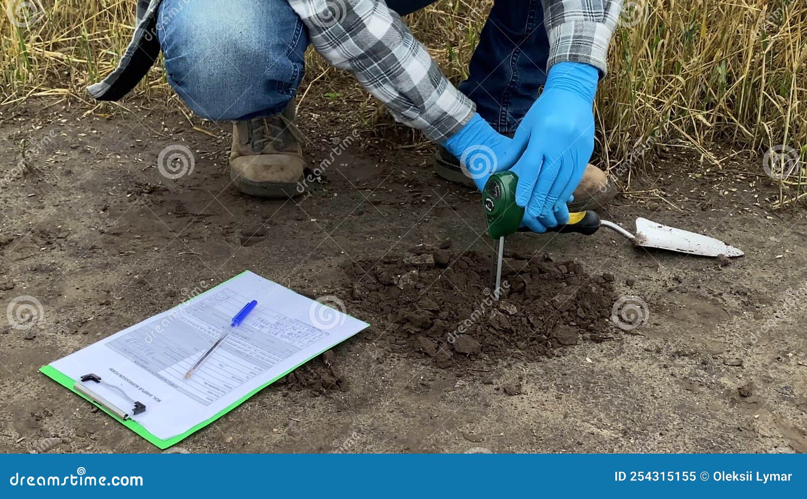Professional Farmer Measuring Soil Features Using Soil Tester Outdoors ...