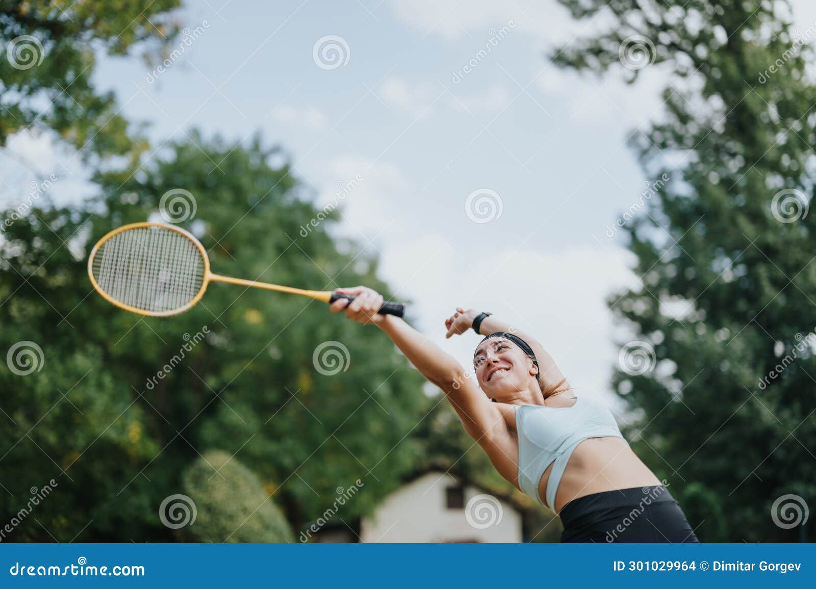 Professional, Female, Badminton Player Reaching for a Shuttlecock with ...