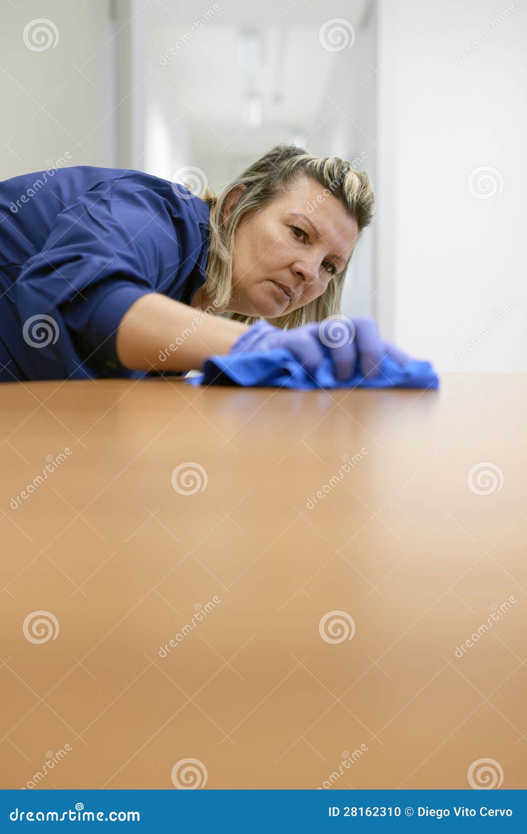 Professional Female Cleaner Wiping Table in Office Stock Photo - Image ...