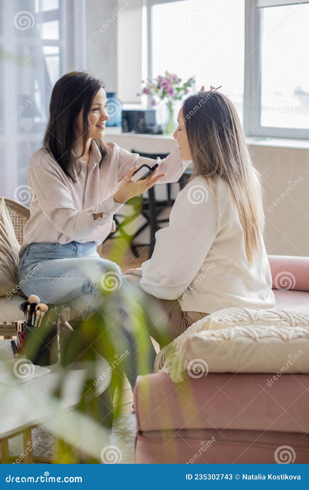 Professional Female Makeup Artist Applying Cosmetics On Model Face Use
