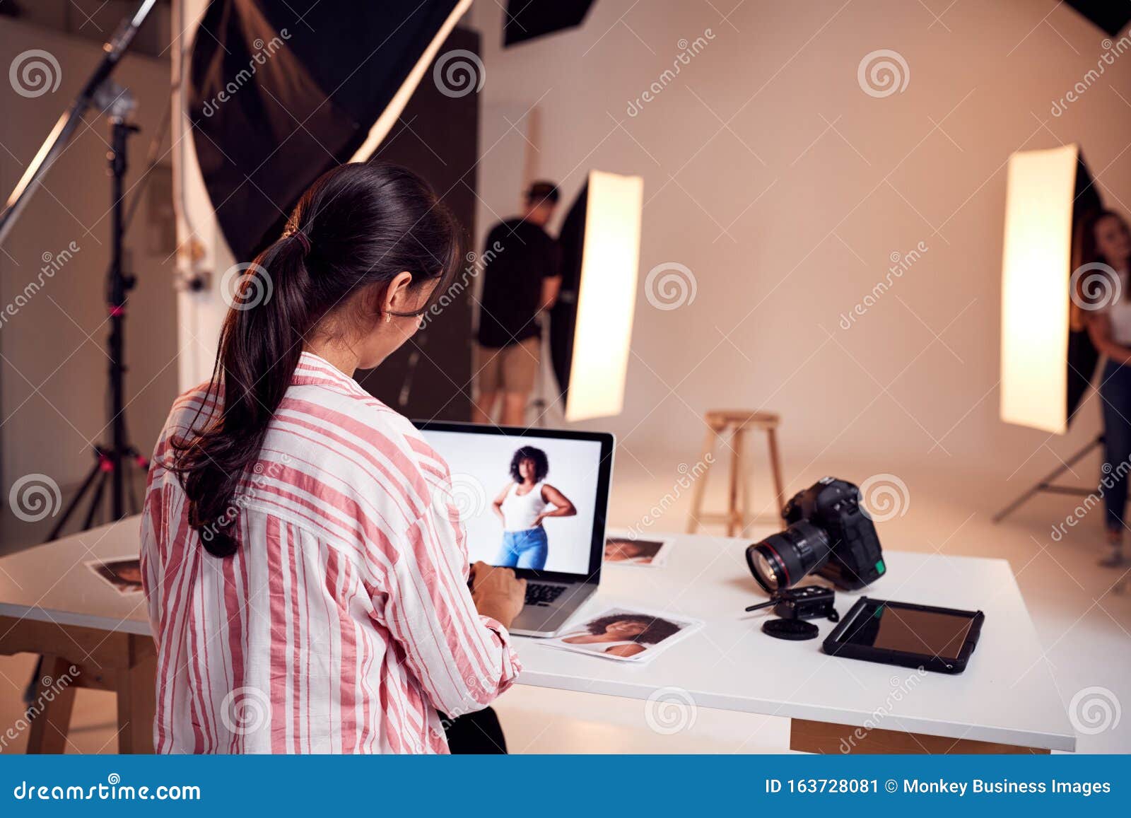 Professional Female Photographer Working in Studio with Assistants in ...