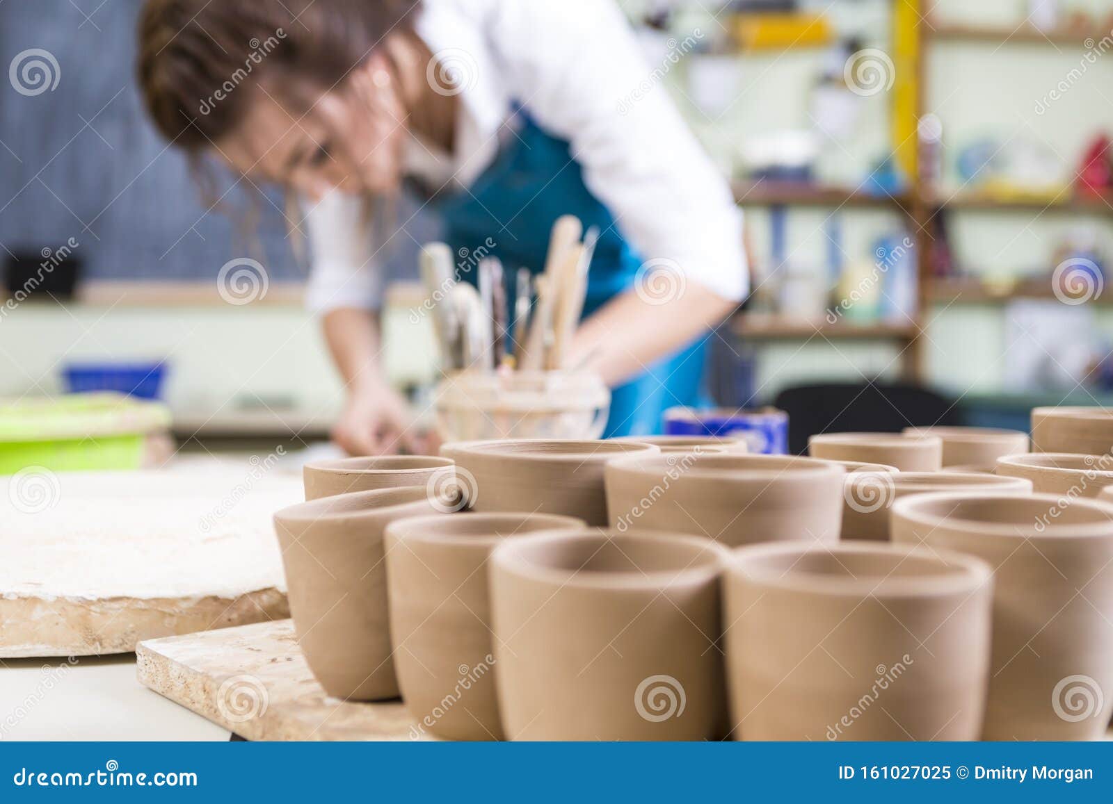 Professional Female Potter during Working Process with Clay in Workshop ...