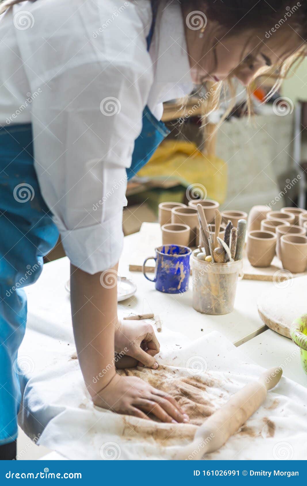Professional Female Worker in Apron Preparing a Piece of Clay Using ...
