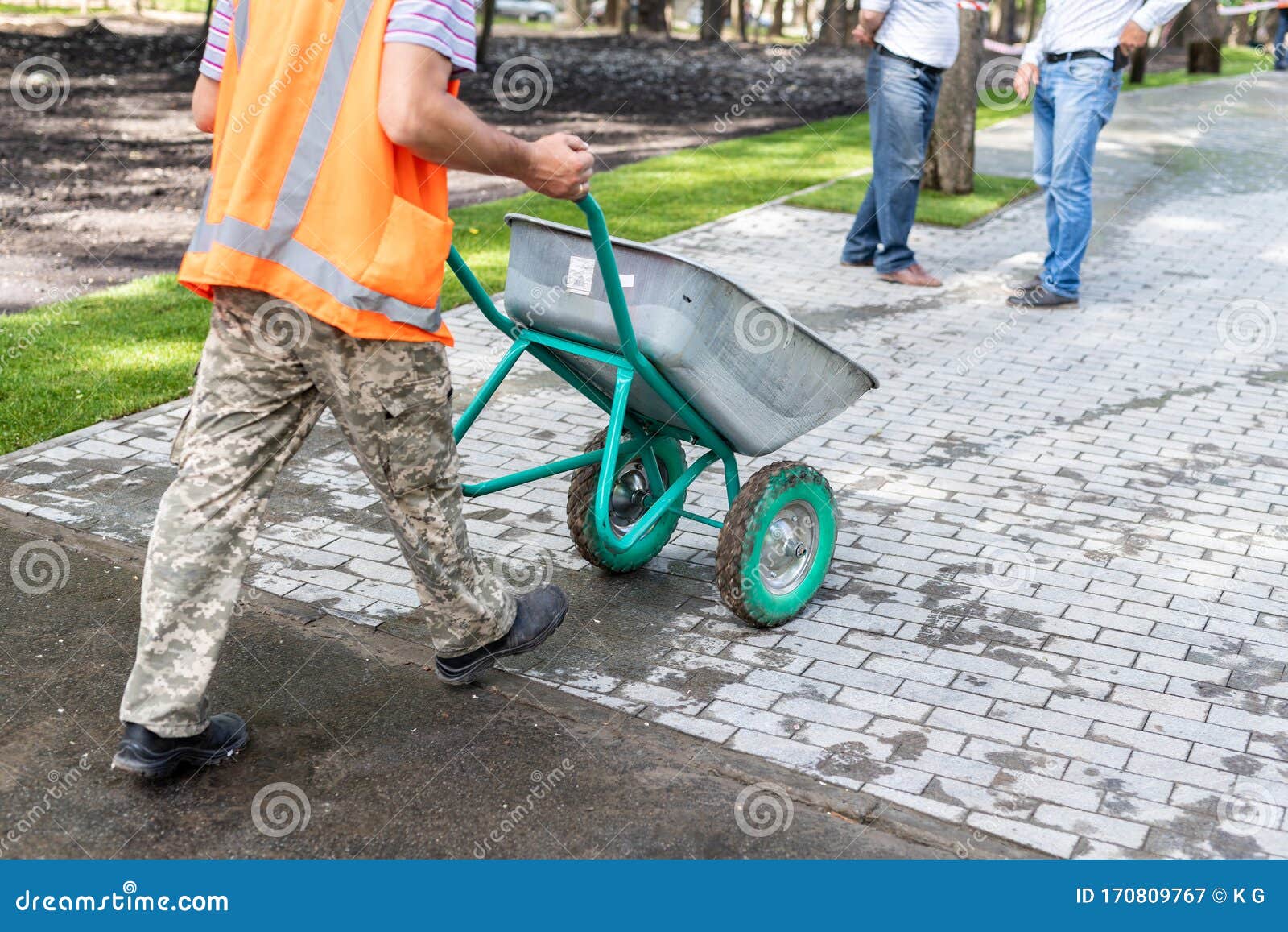 Professional Gardener Worker Walkink with Wheel-barow at Park ...