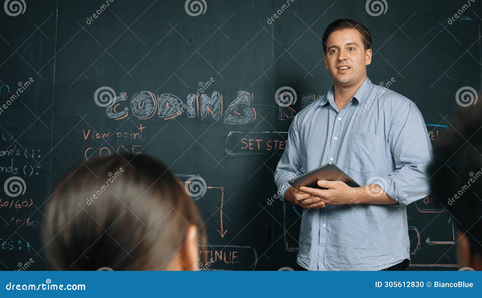 Caucasian Teacher Answering Student Question about Coding Program ...