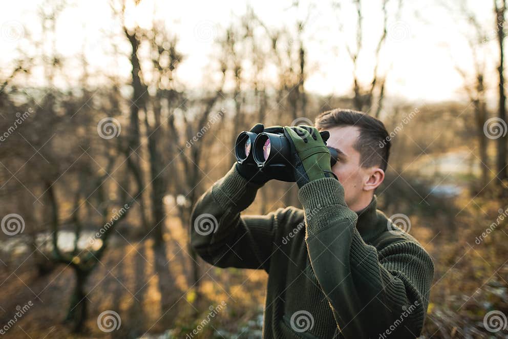 Professional Hunter Looking through Binoculars. Man on the Hunt in the ...