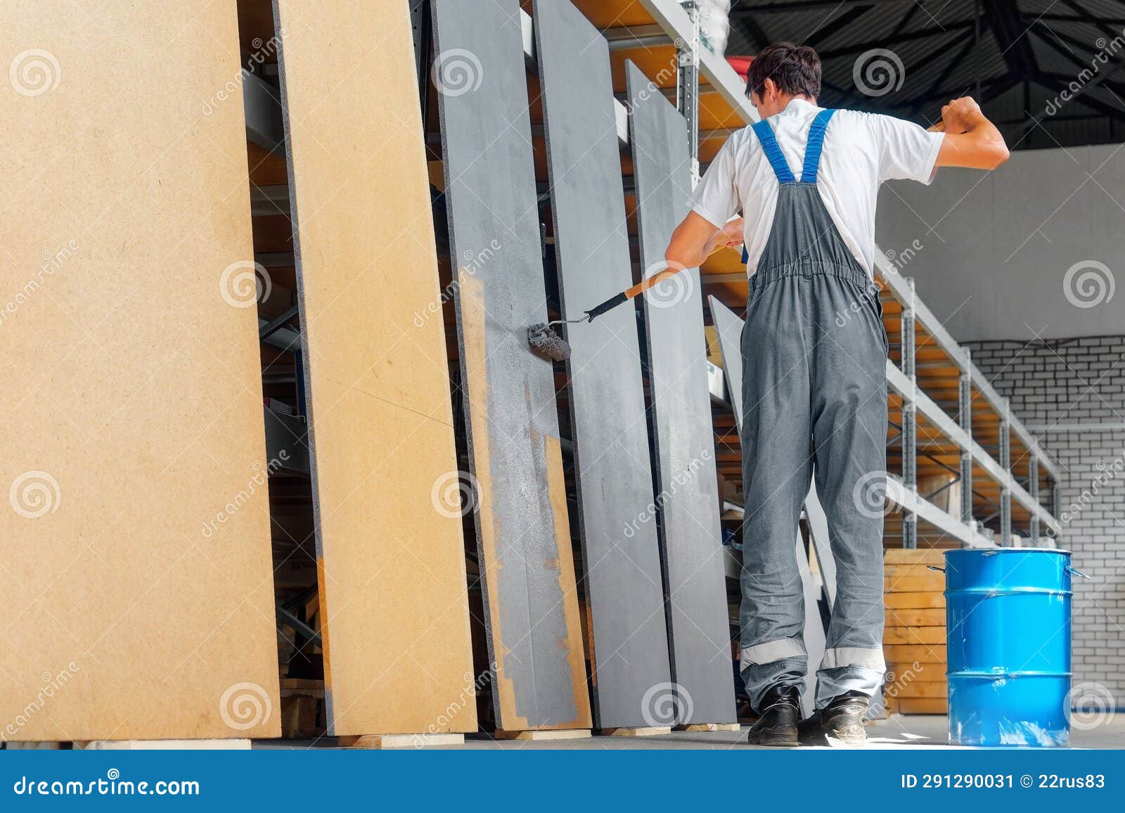 Professional Industrial Painter Paints Wooden Boards with Paint Roller ...