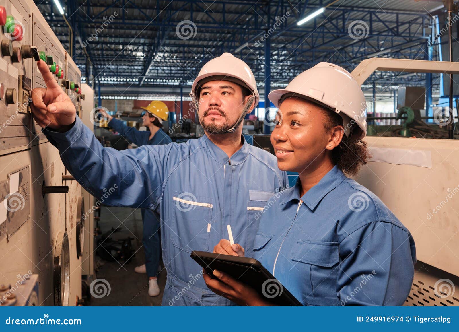 Industry Engineers Inspect Machine Control Panels in Manufacturing ...