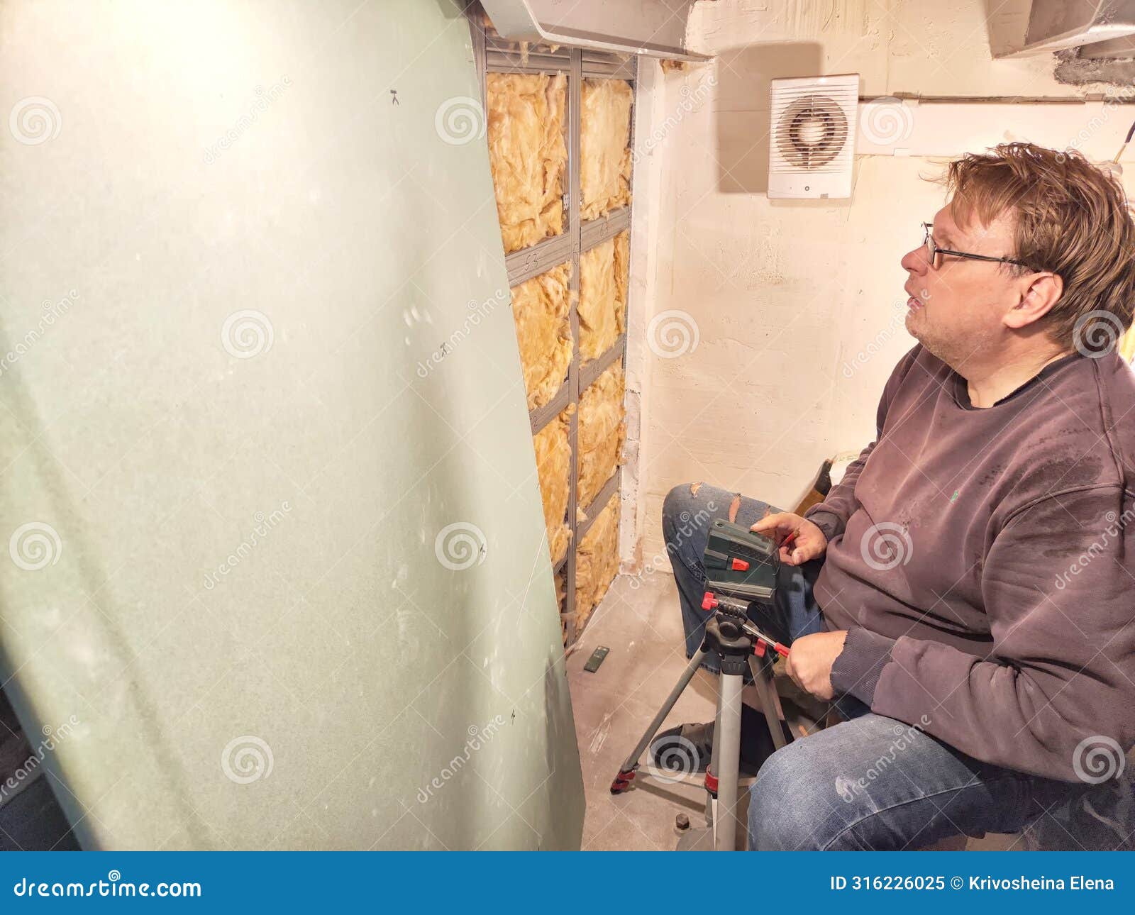 Professional Installs Drywall during Home Renovation. a Skilled Worker ...