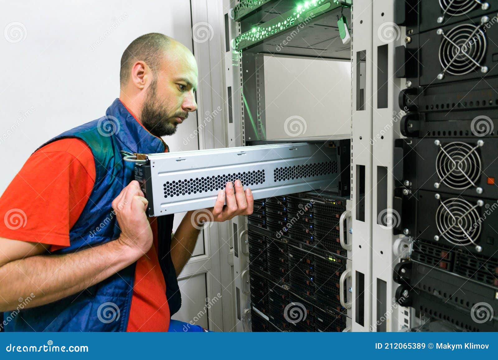 A Professional Installs a New Battery Pack into an Uninterruptible ...