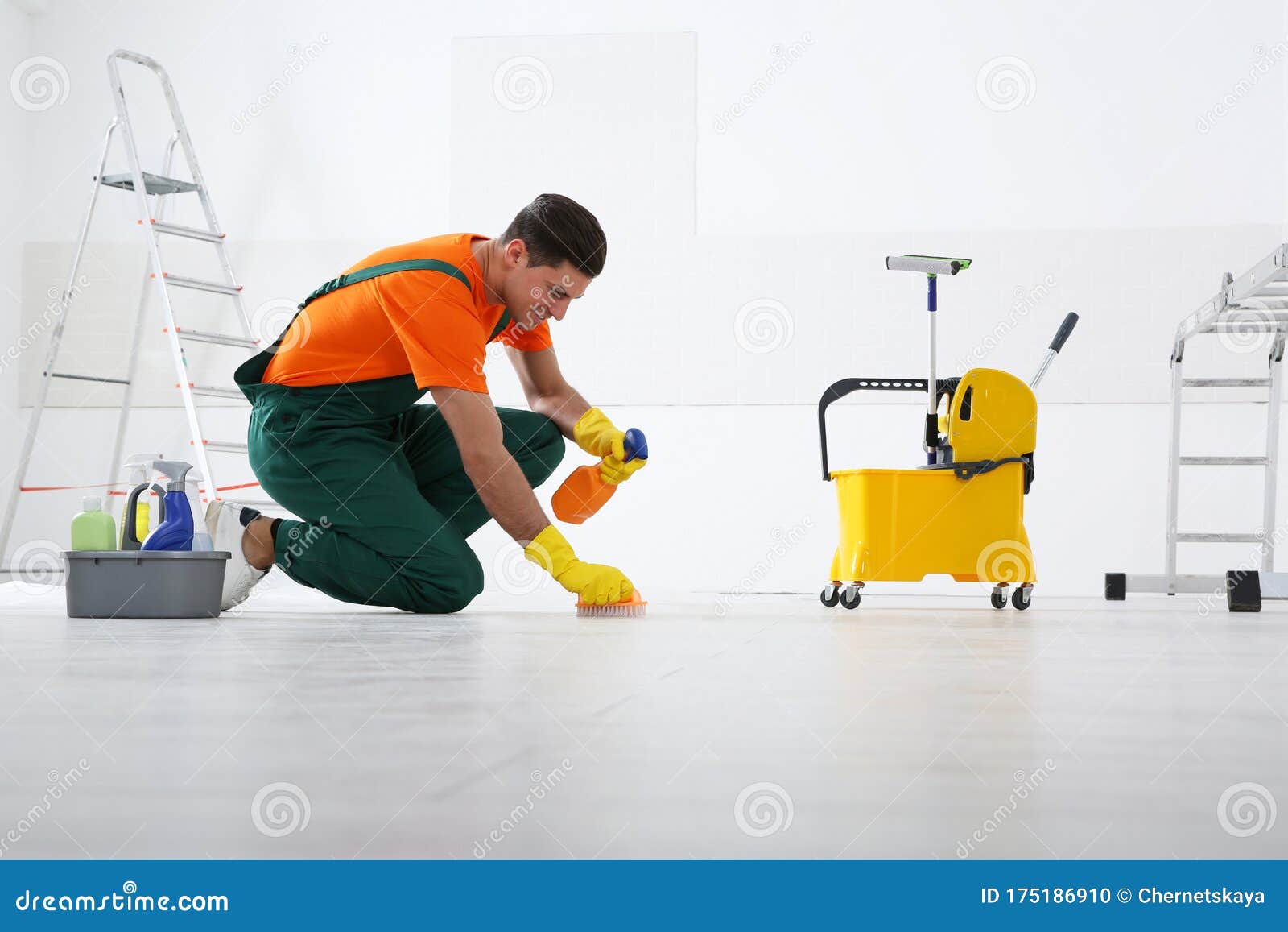 Janitor Cleaning Floor with Brush and Detergent after Renovation Stock ...