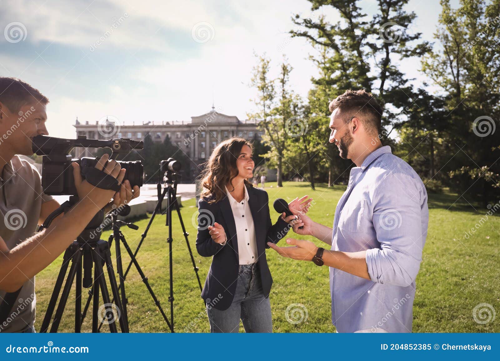 Professional Journalist and Operator with Video Camera Taking Interview ... Professional Journalist and Operator with Video Camera Taking Interview ...