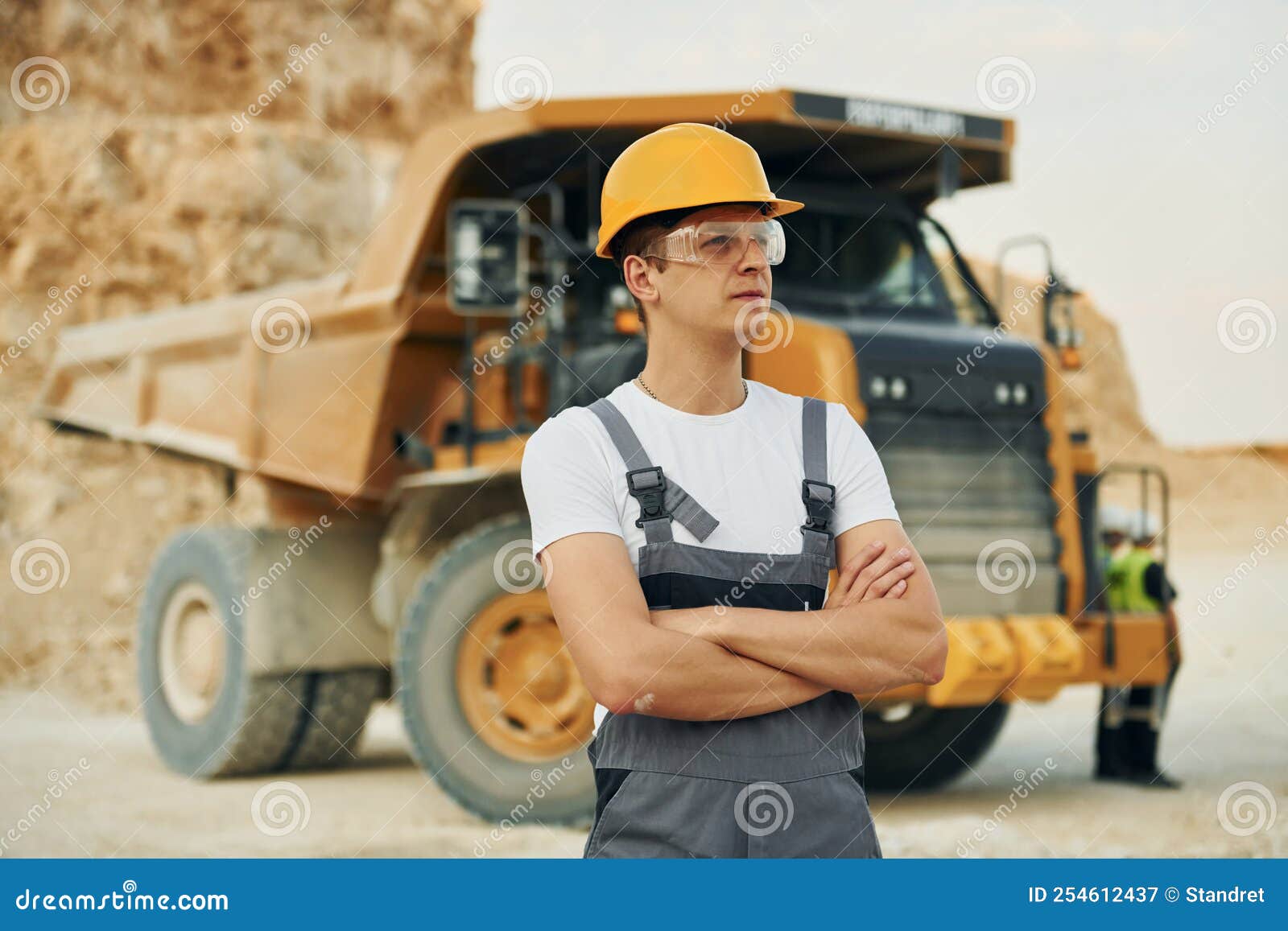 Professional Loading Vehicle. Worker in Uniform is on the Borrow Pit at ...