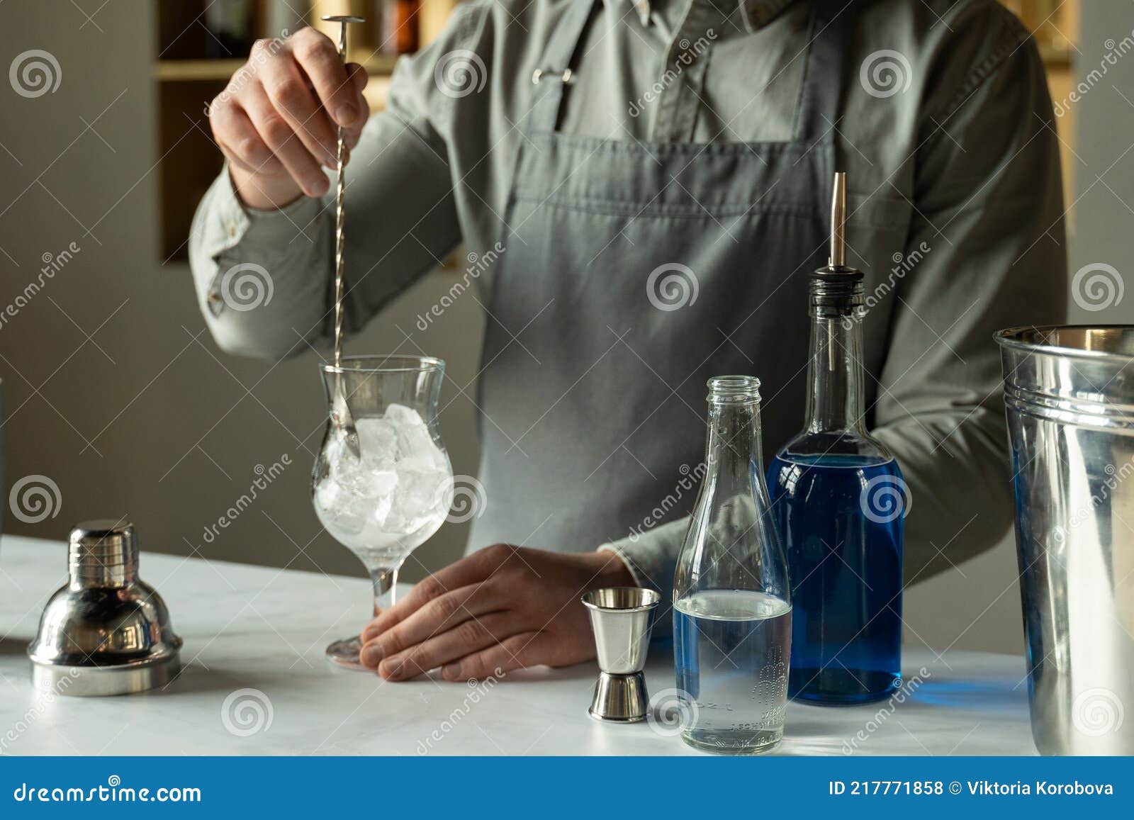 Bartender Stirring With A Spoon A Yellow Achoholic Drink In A Co Stock ...