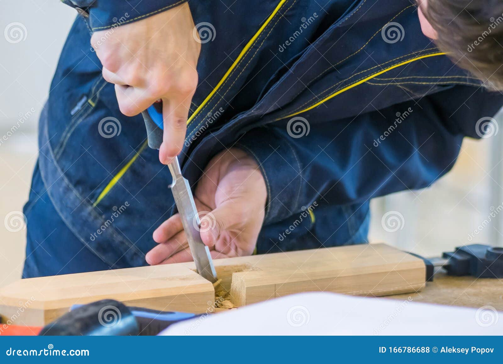 Carpenter Using Chisel To Carve Wood on Rough Workbench at Workshop ...