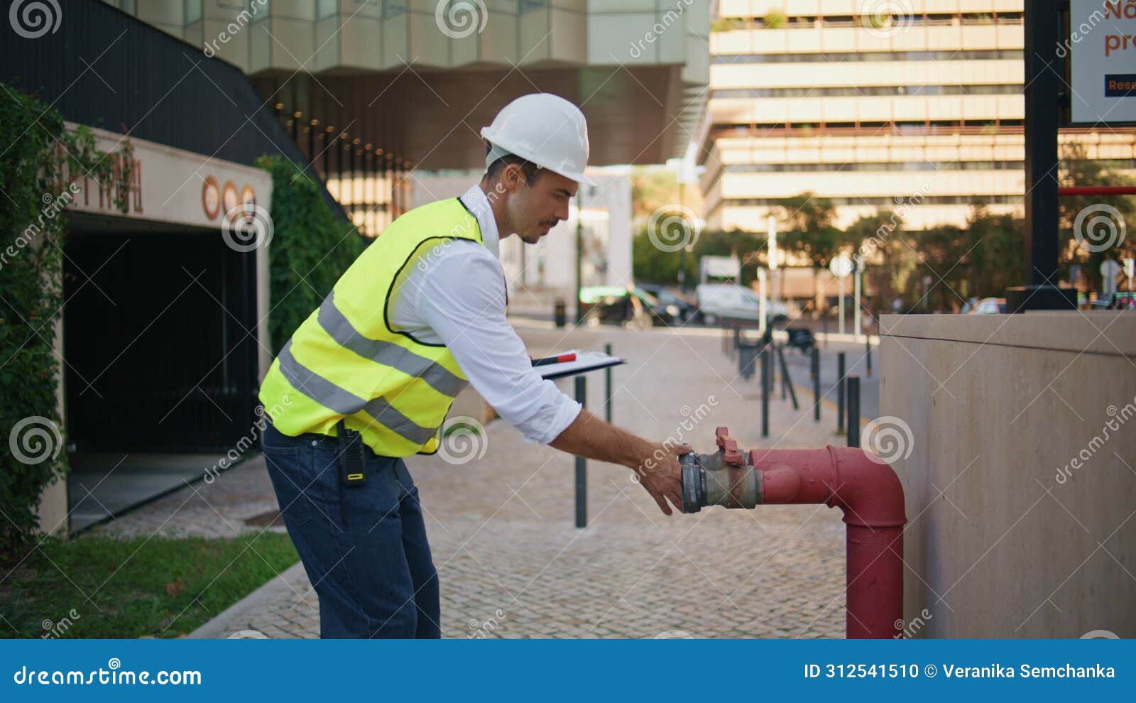 Professional Man Examining Pipe Making Notes at Street. Expert Writing ...