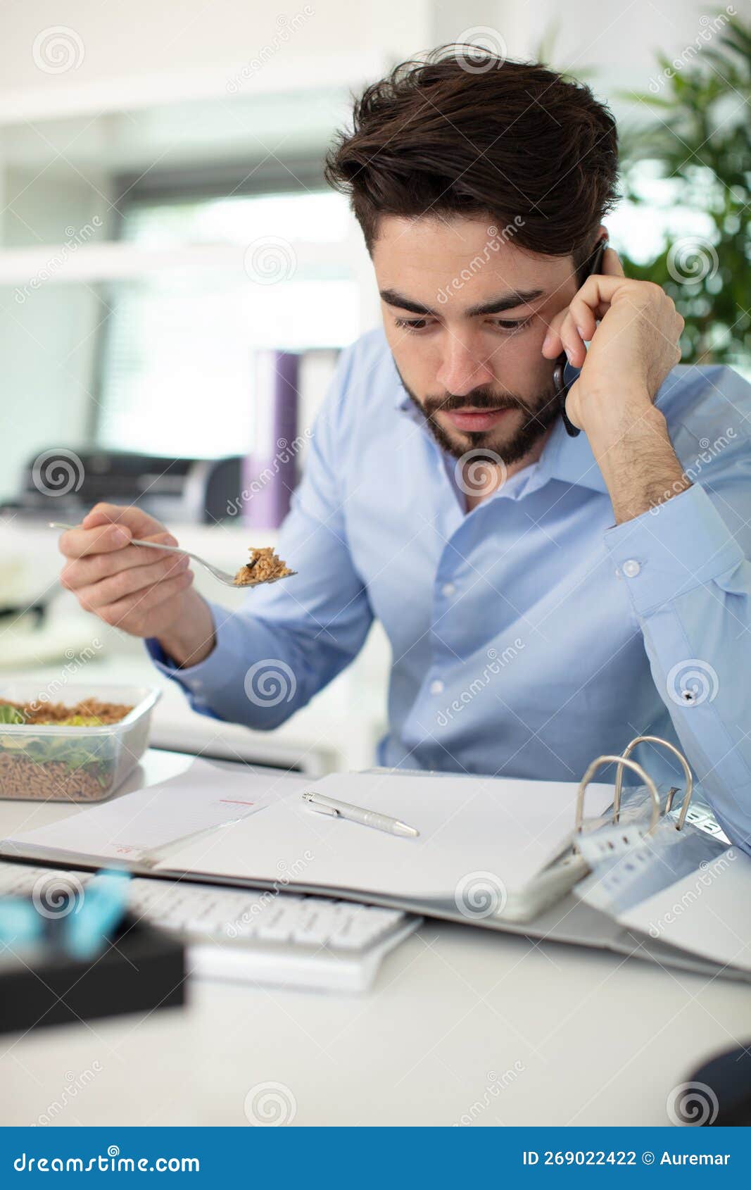 Professional Man Working through Lunch Eating Packaged Food Stock Photo ...