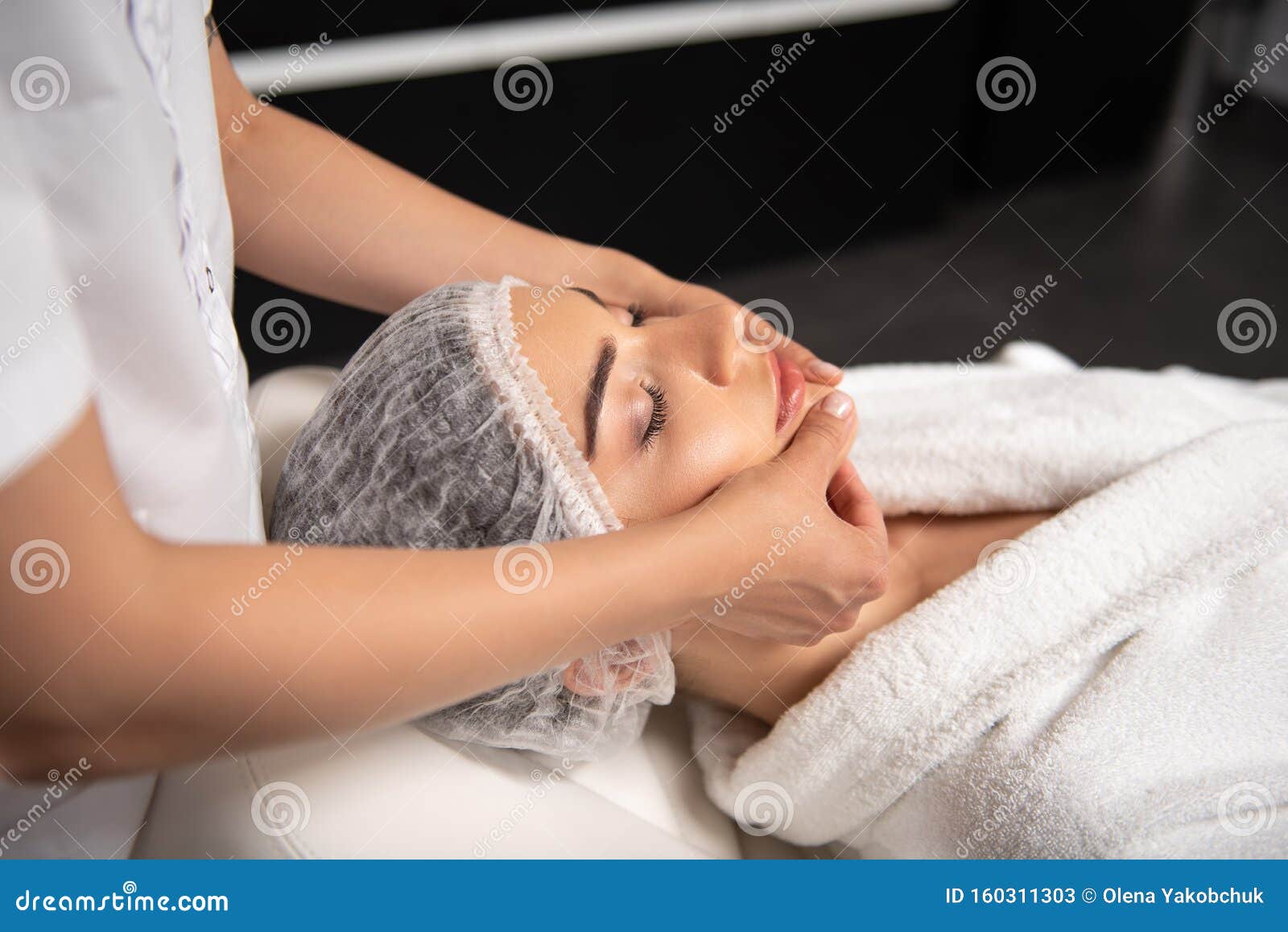 Professional Masseuse Massaging Lady Face At Spa Salon Stock Image