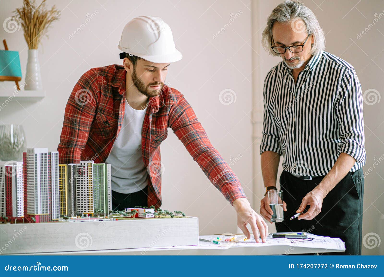 Professional Mature Architect Sharing Experience with Trainee Stock ...