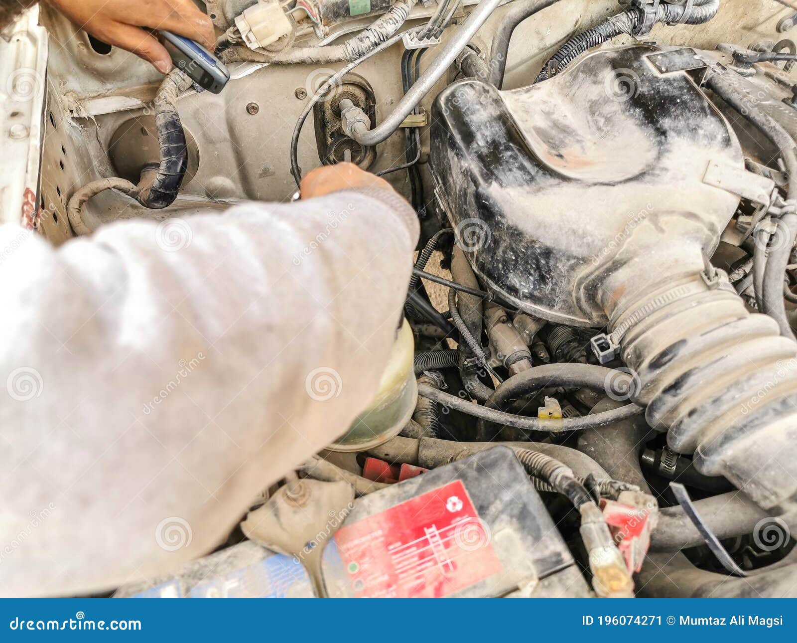 A Professional Mechanic is Replacing the Battery of a Modern Vehicle ...