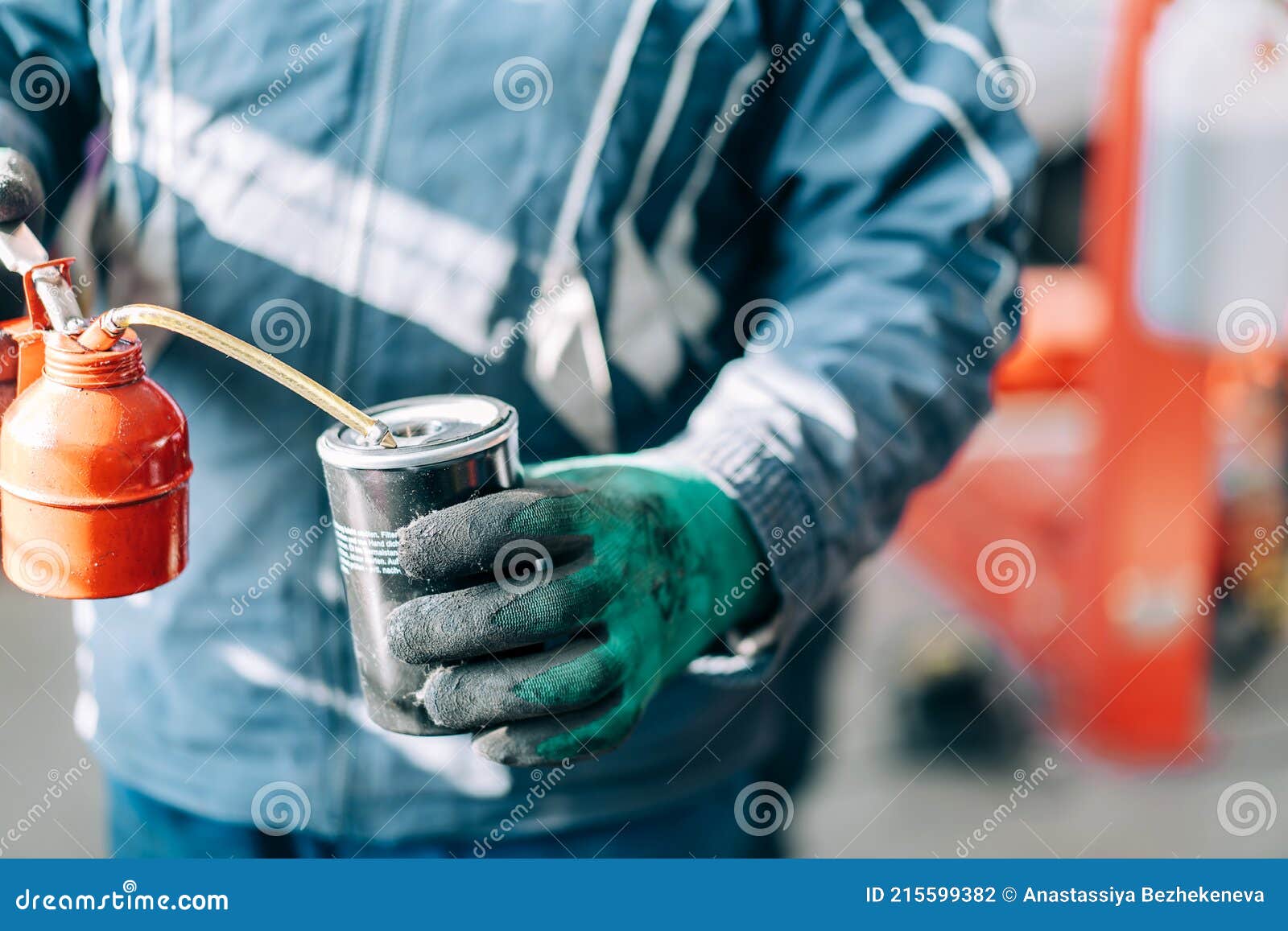 Professional Mechanic in Uniform Holding an Oil Filter for an Internal ...