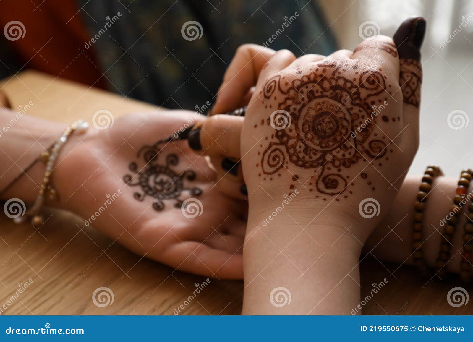 Professional Mehndi Master Making Henna Tattoo at Table, Closeup Stock ...