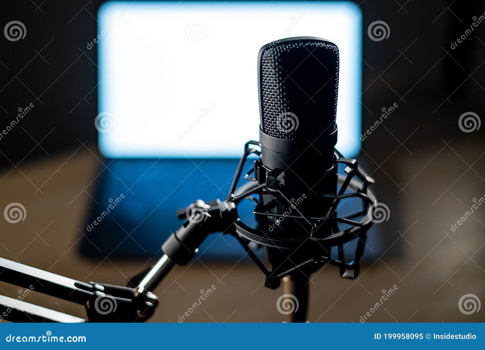 Professional Microphone and Laptop with White Screen in the Dark ...