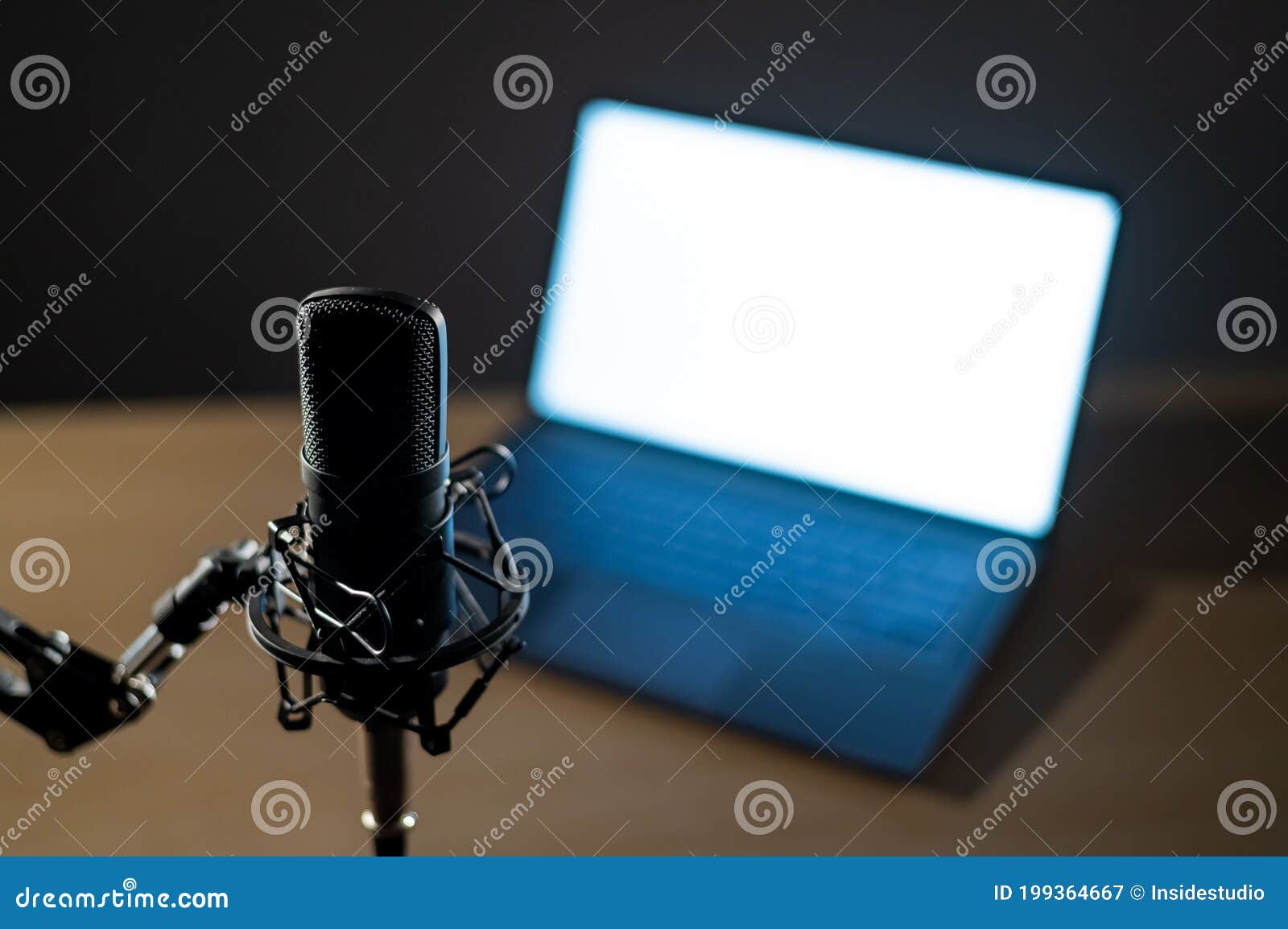 Professional Microphone and Laptop with White Screen in the Dark ...