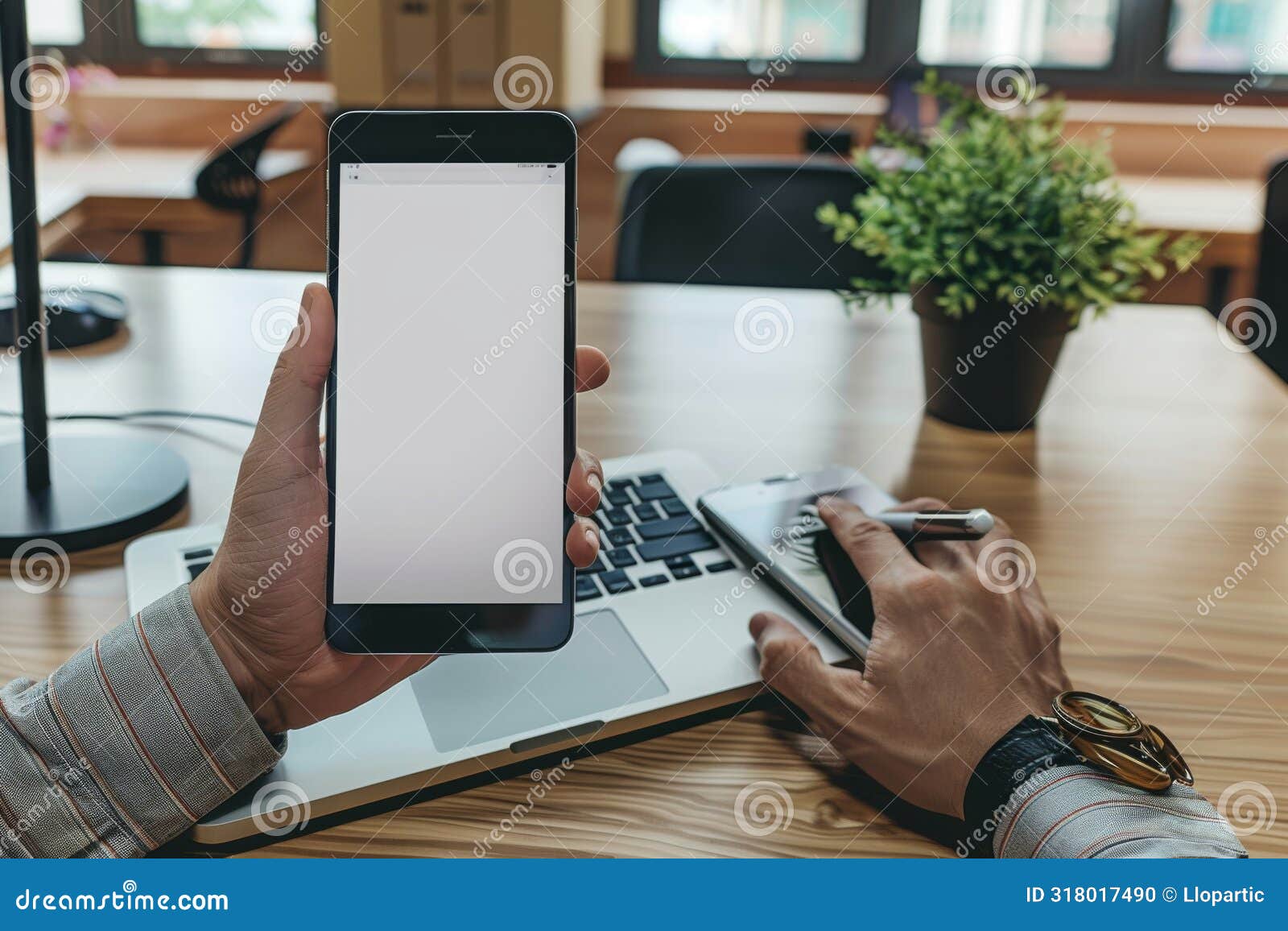Professional Multitasking with a Smartphone and Laptop in a Modern ...