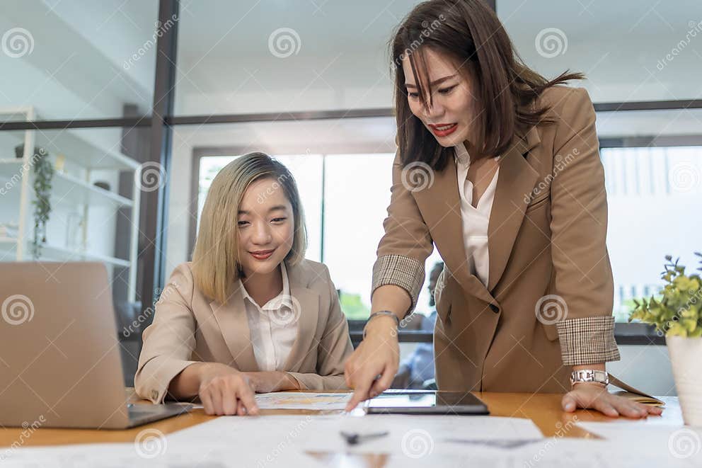 Professional Office Workers Discussing on Documents Together in the ...