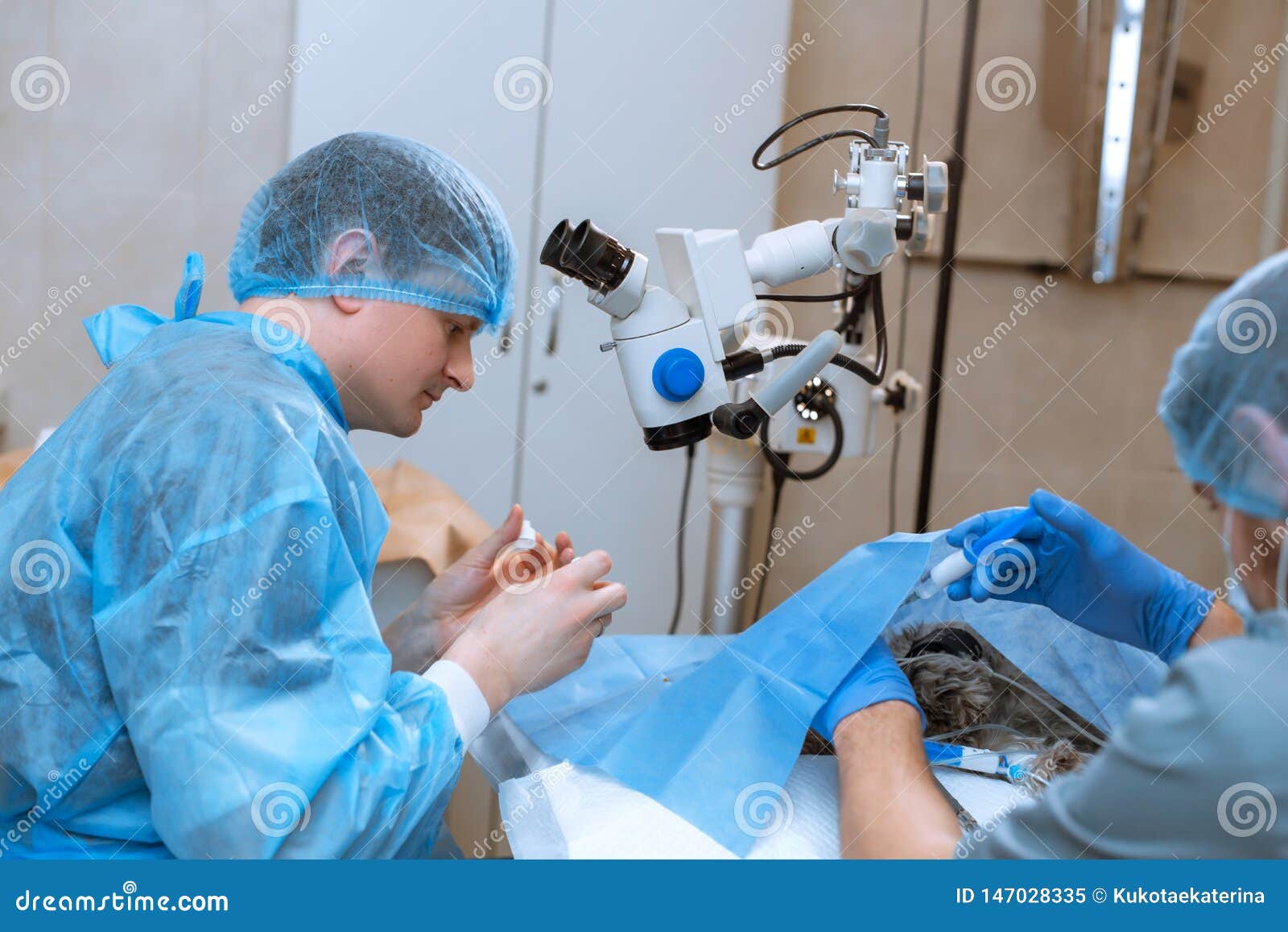 A Professional Ophthalmologist Performs Eye Surgery with a Microscope ...