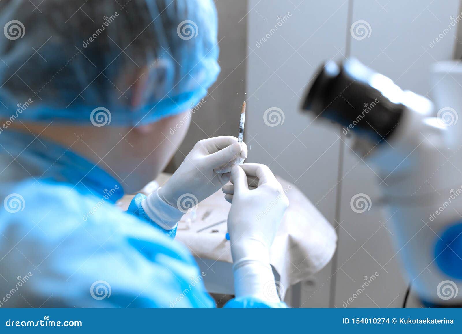 A Professional Ophthalmologist Performs Eye Surgery with a Microscope ...