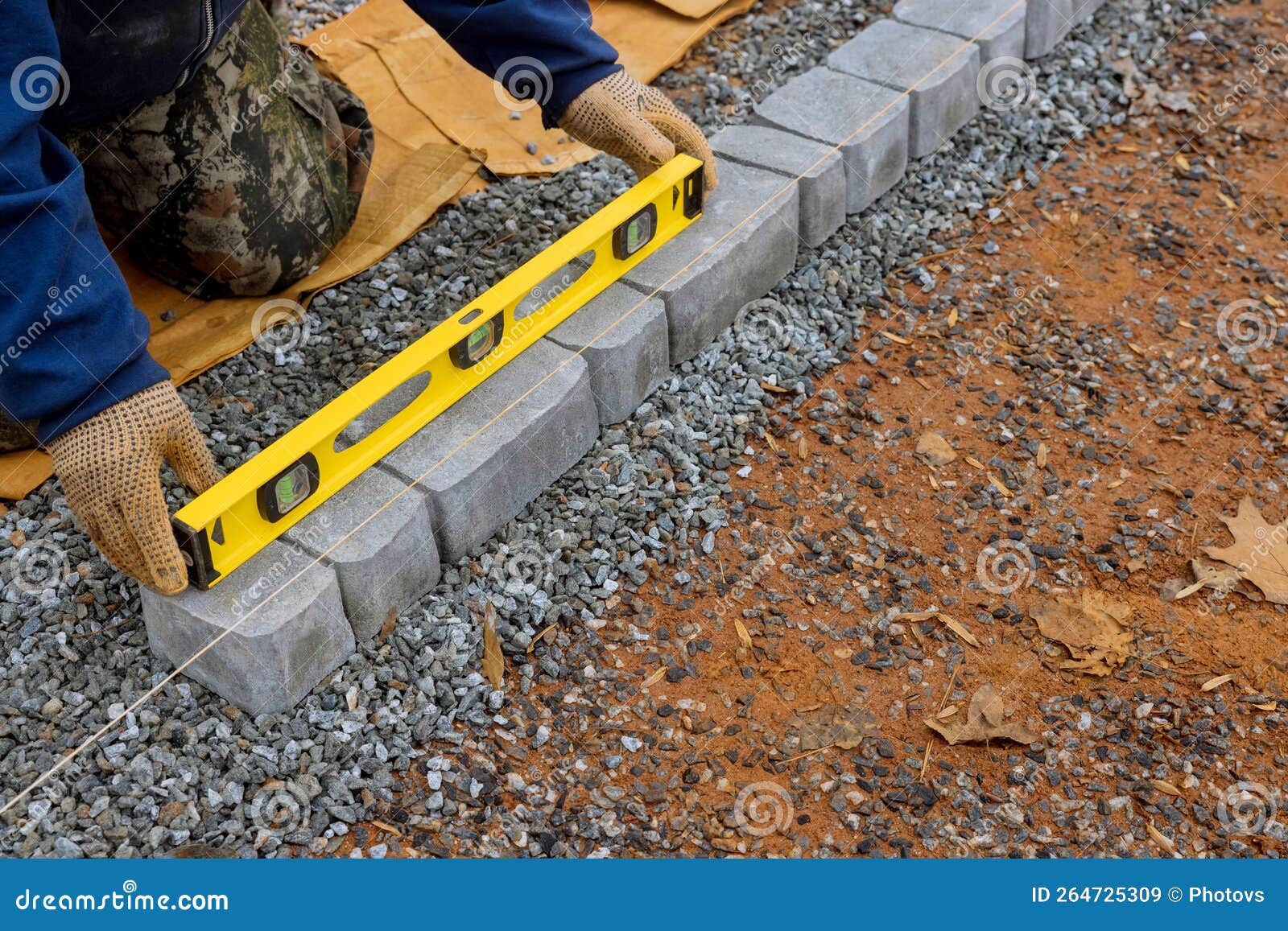 A Professional Paver Worker Performs the Laying of Stones for the ...