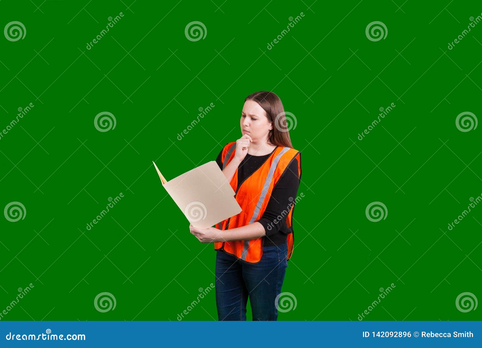 Female Safety Worker Holding Open Folder Reading File Unsure Expression ...