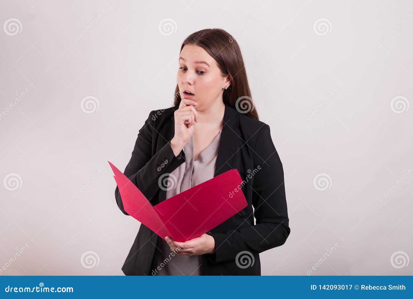 Buisness Professional Reading Open Folder Unsure Expression on Her Face ...