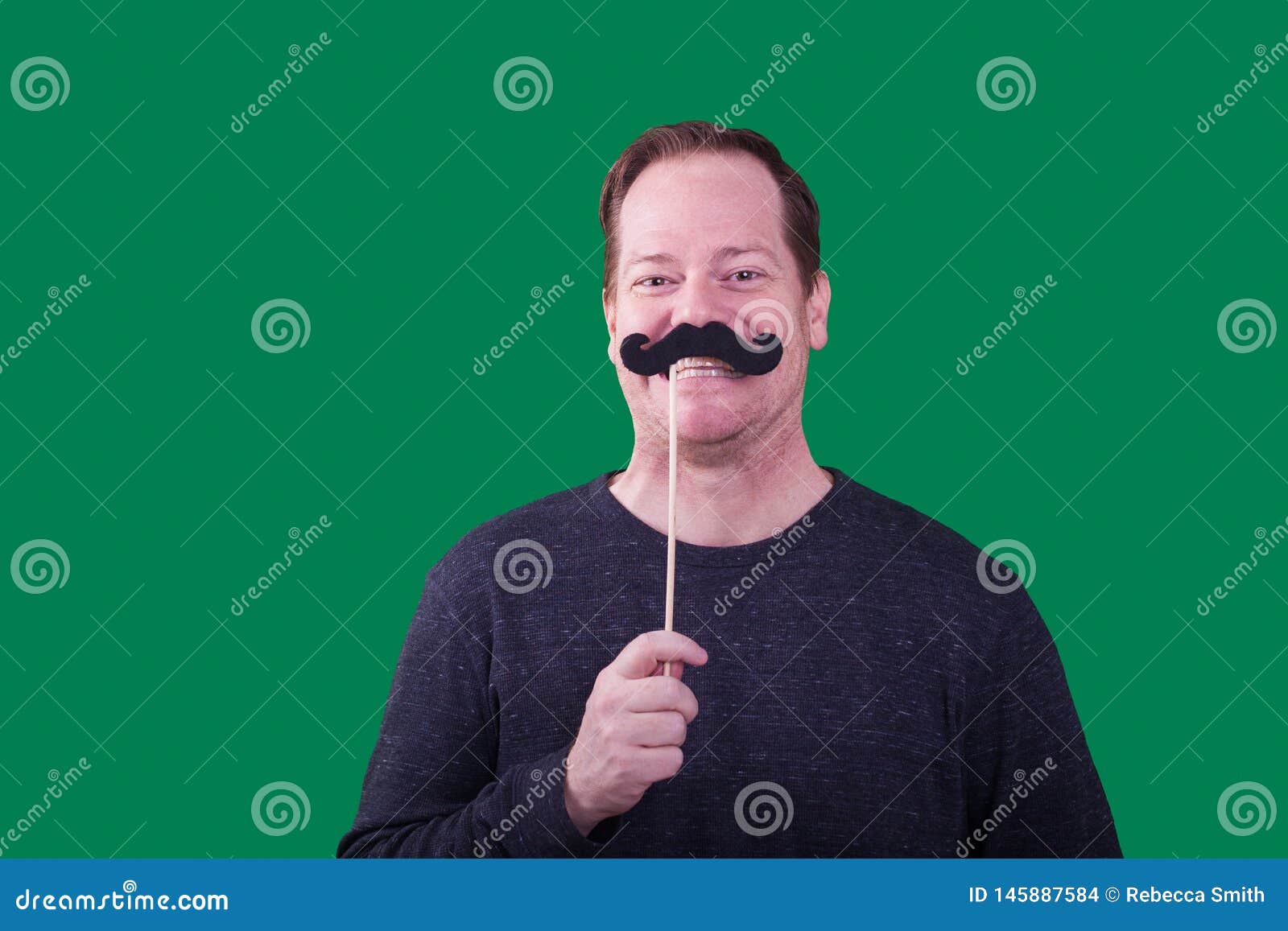 Adult Man Holding Fake Mustache Up To Face Smiling on Green Screen ...