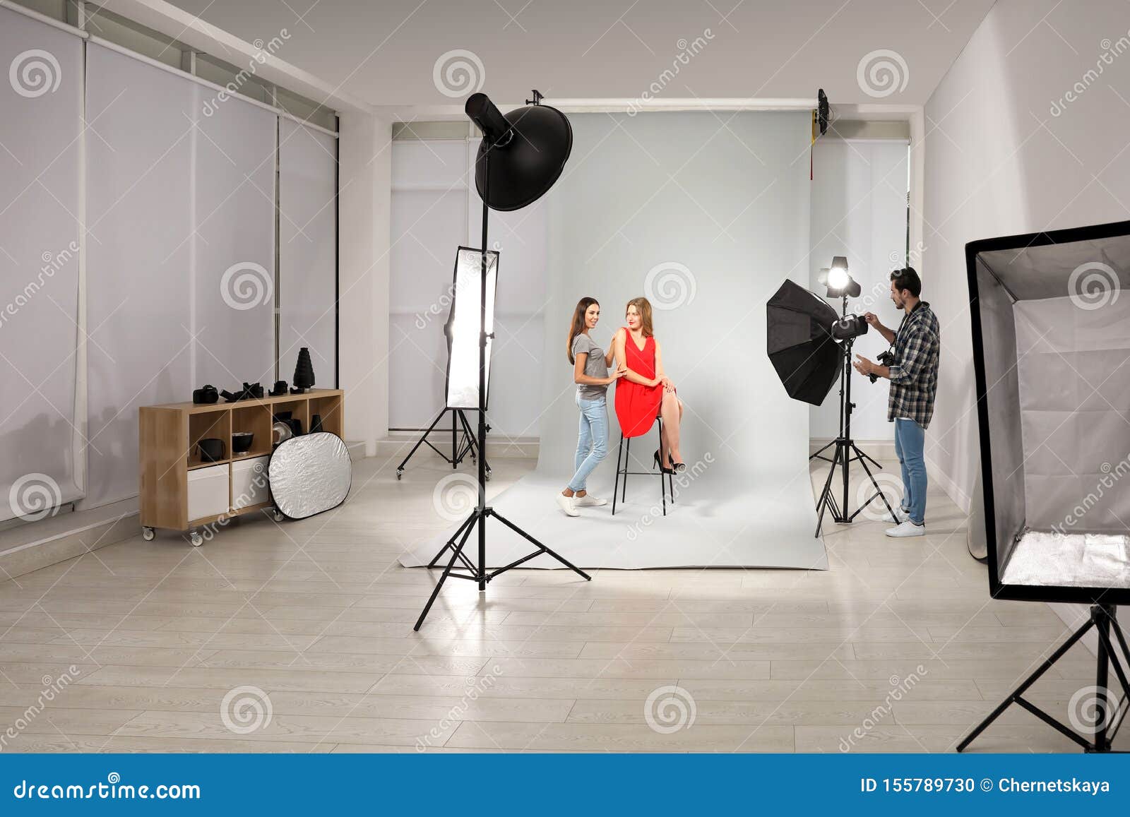 Professional Photographer and Assistant with Model in Modern Studio ...
