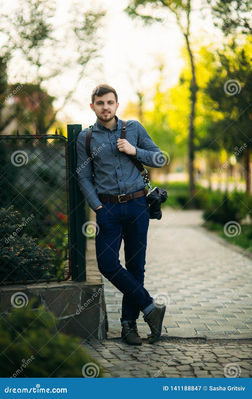 Professional Photographer with Camera Stand Outside and Wait for the ...