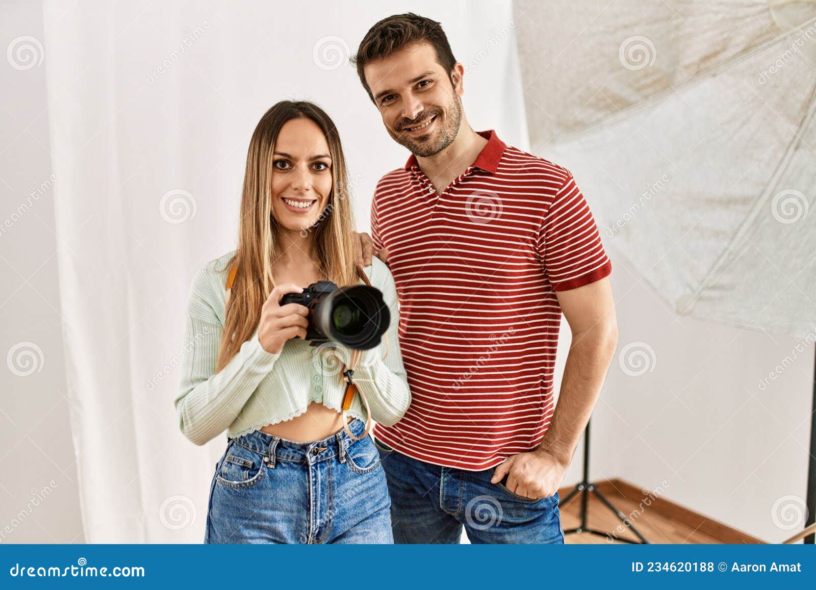 Professional Photographer and Model Holding Camera Standing at ...