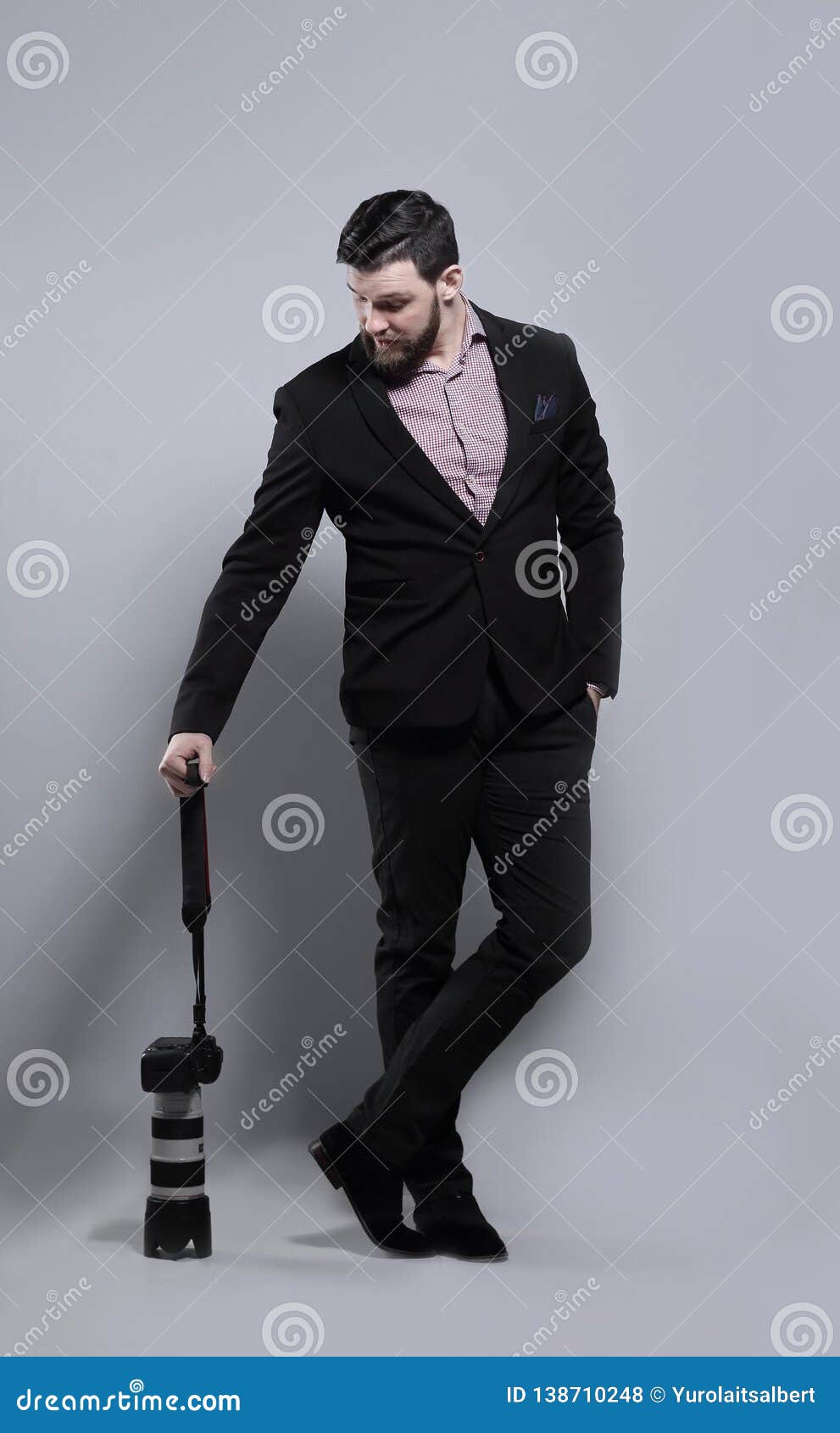 Professional Photographer Puts the Camera on the Floor.isolated on Grey ...