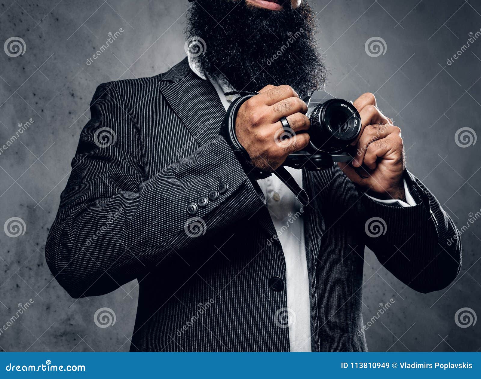 Professional Photographer in a Suit Shooting with a Compact DSLR Camera ...