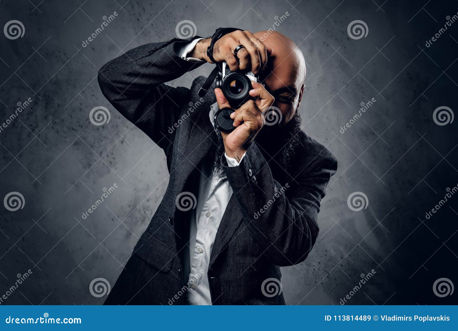 Professional Photographer in a Suit Shooting with a Compact DSLR Camera ...