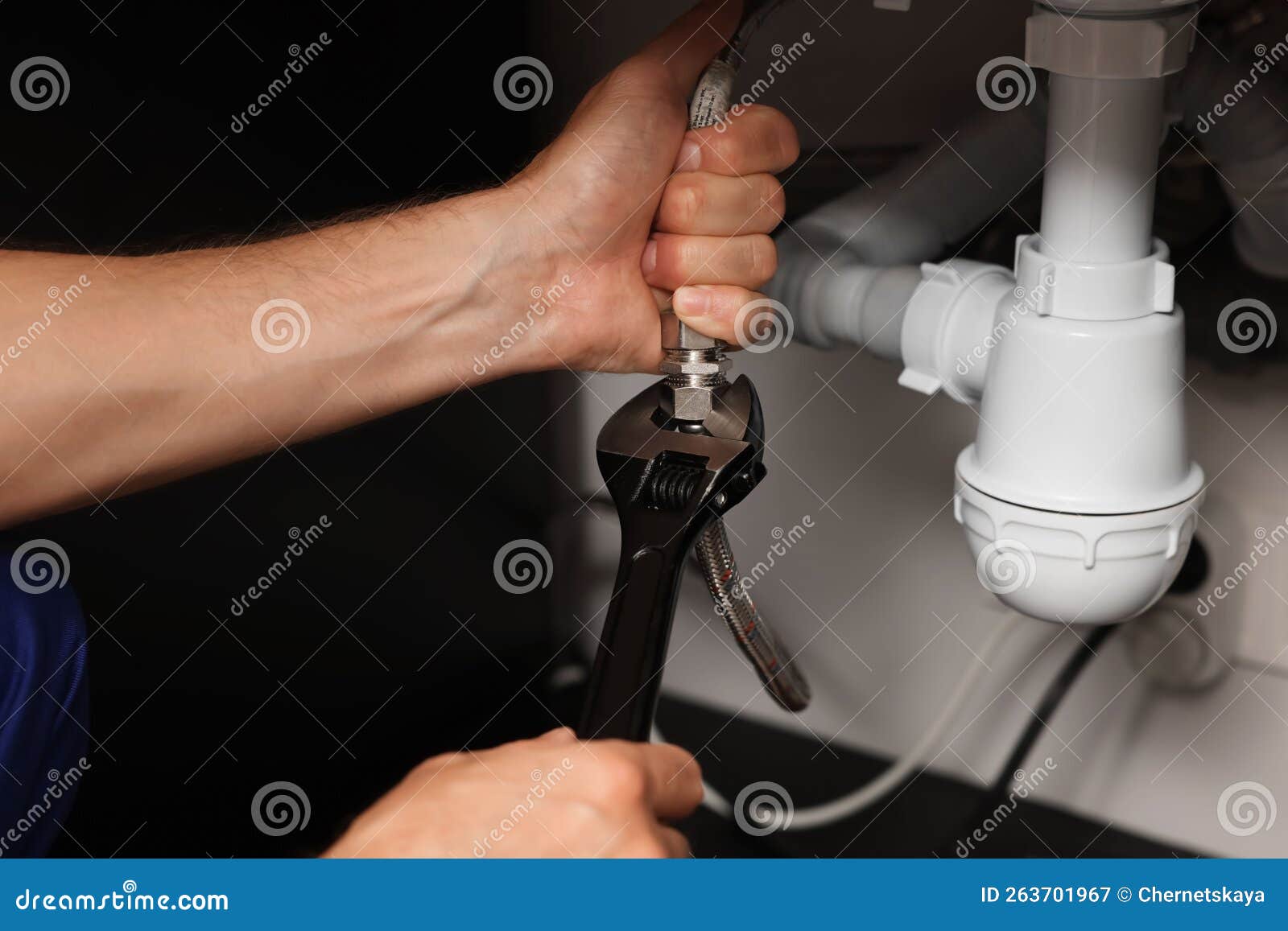 Professional Plumber with Adjustable Wrench Fixing Sink, Closeup Stock ...