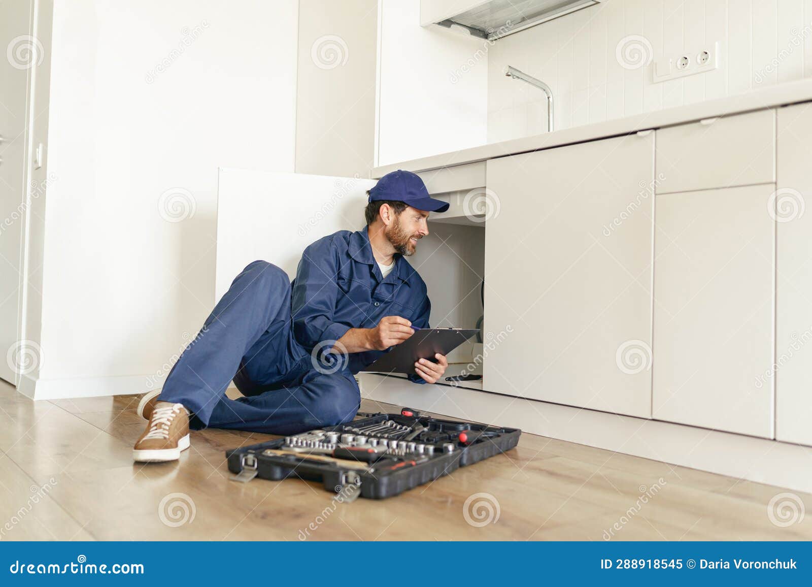 Professional Plumber Examine a Siphon Pipe on the Kitchen Sink after ...