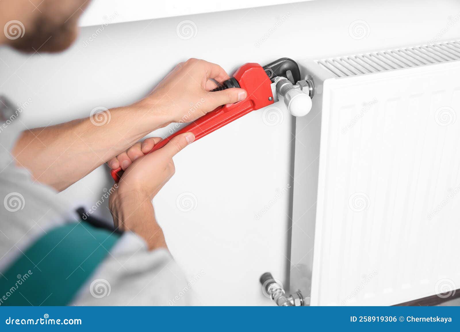 Professional Plumber Using Adjustable Wrench for Installing New Heating ...
