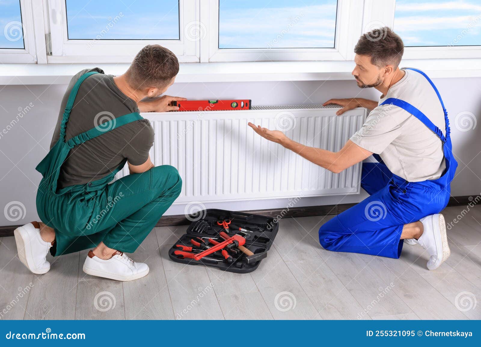 Professional Plumbers Using Bubble Level for Installing New Heating ...