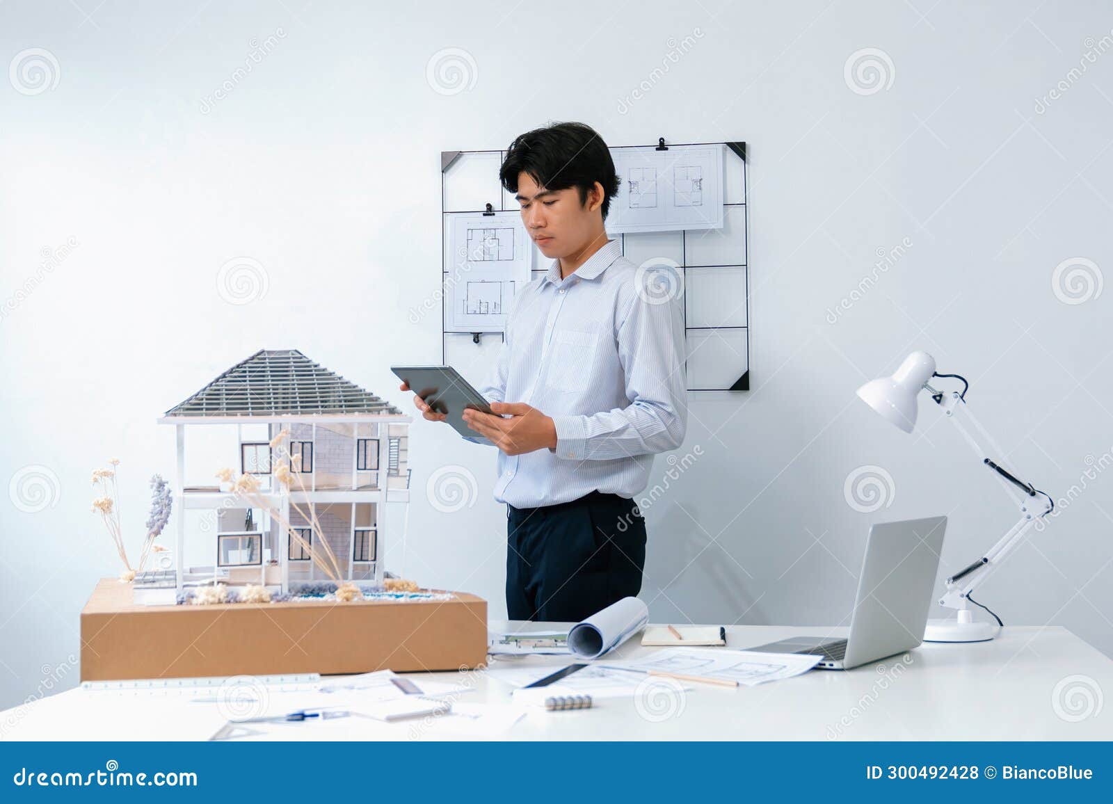 Professional Project Manager Using Tablet To Check House Model ...